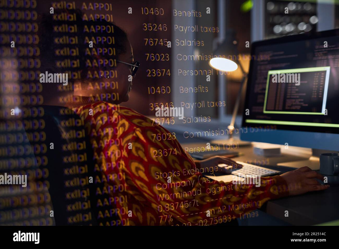 African American programmer working with program codes till late night sitting at her workplace ...