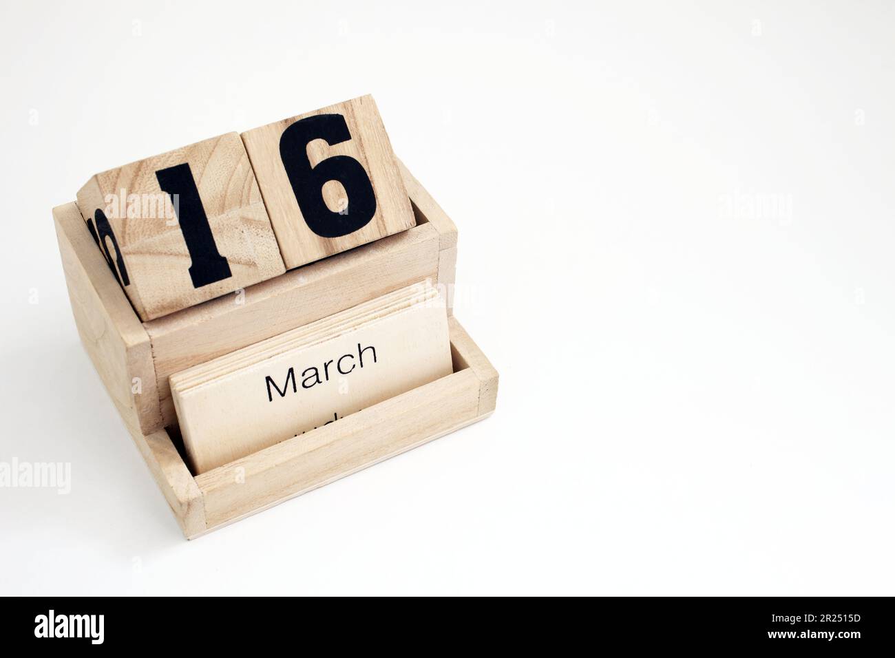 Wooden perpetual calendar showing the 16th of March Stock Photo - Alamy