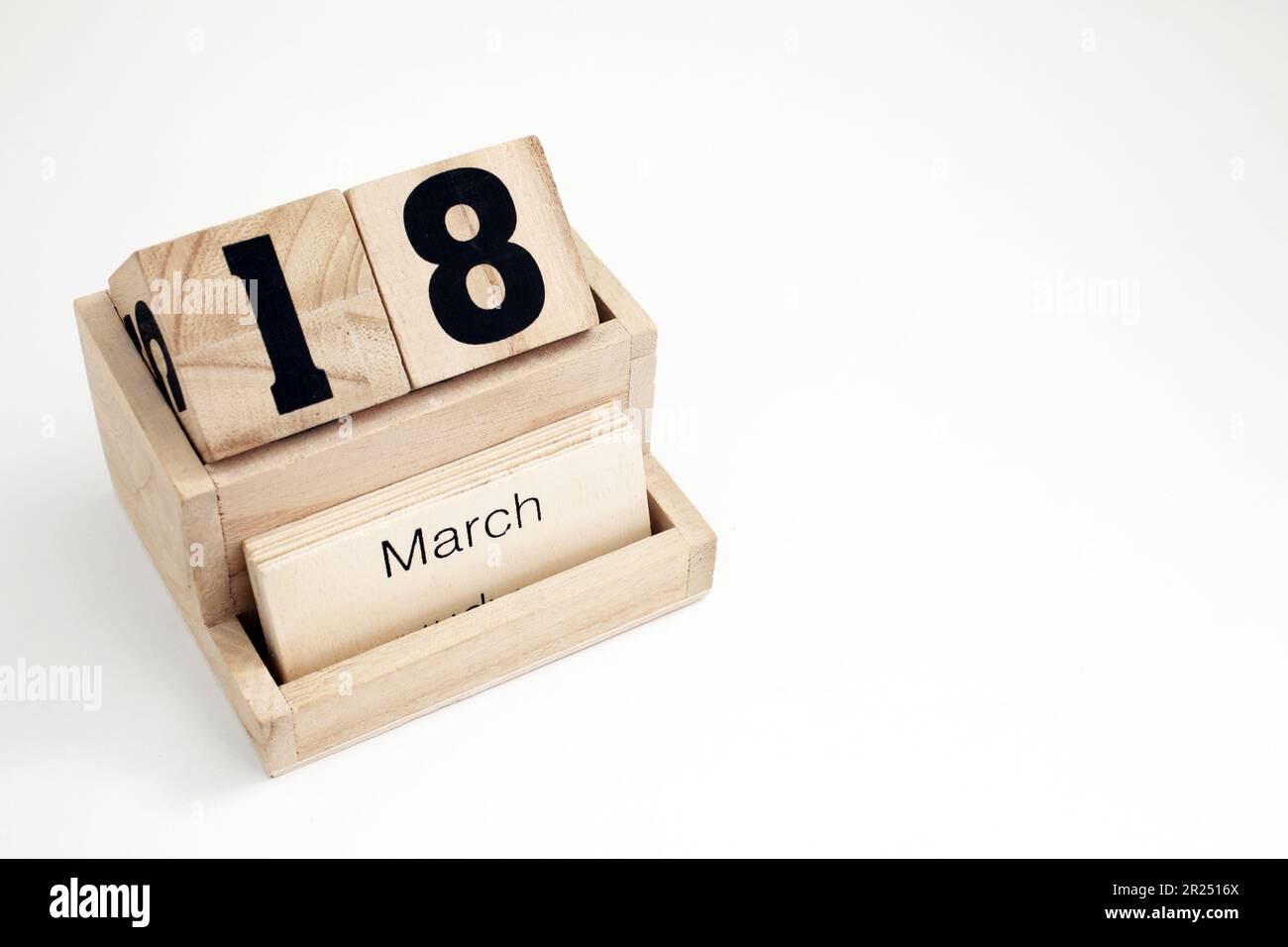 Wooden perpetual calendar showing the 18th of March Stock Photo - Alamy