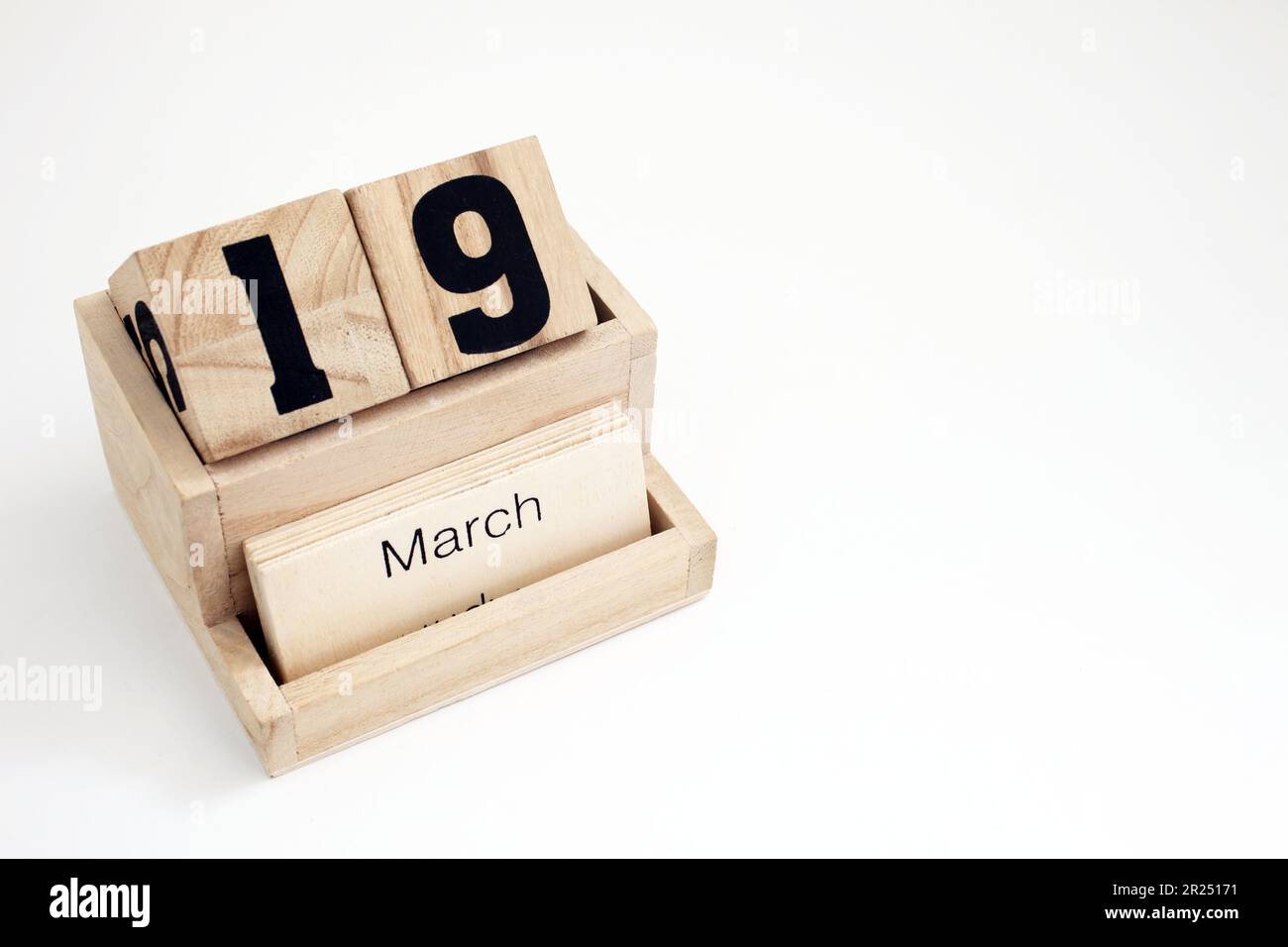 Wooden perpetual calendar showing the 19th of March Stock Photo - Alamy