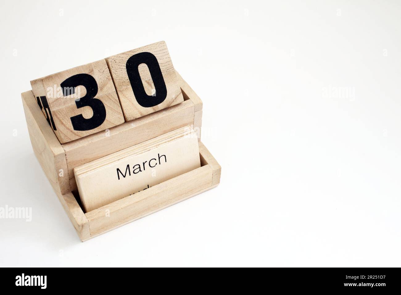 Wooden perpetual calendar showing the 30th of March Stock Photo - Alamy
