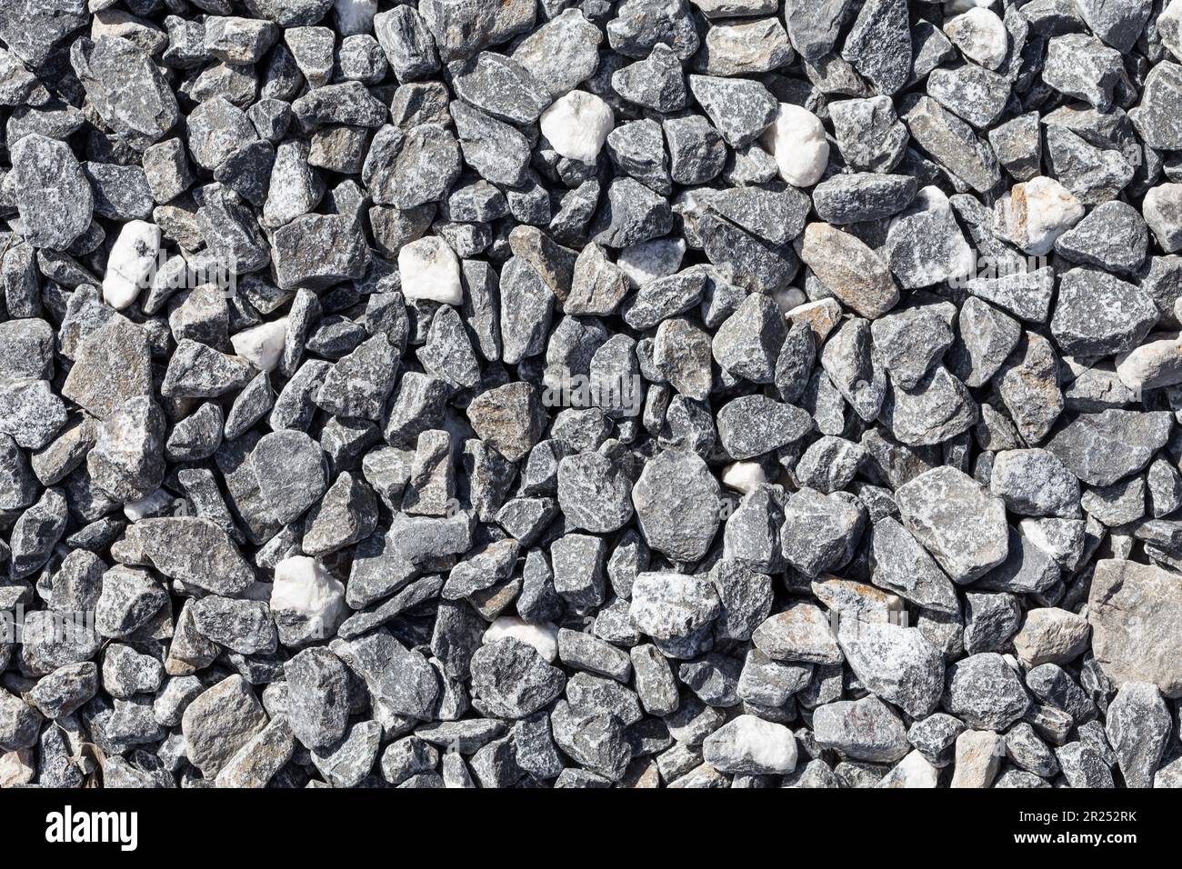 Crushed grey stone on the ground texture background Stock Photo - Alamy