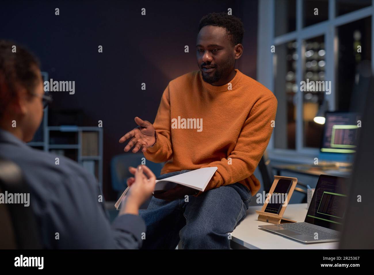 Couple of programmers working over new project in office till late ...