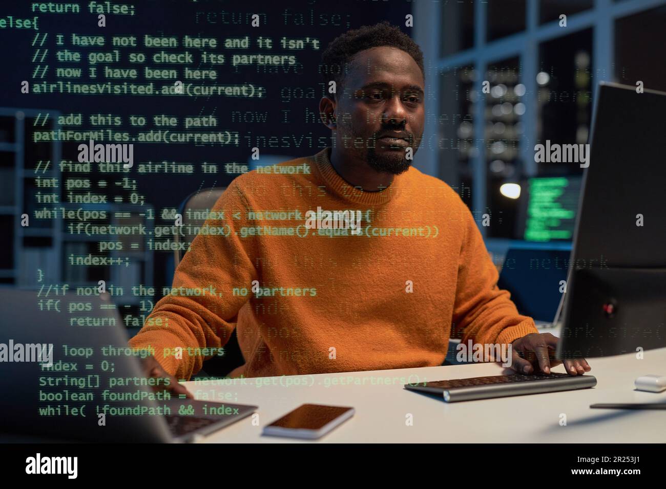 African American developer typing codes on computer while sitting at ...