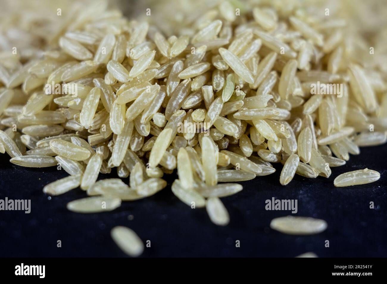 Picture of a pile of brown rice. Brown rice is a whole grain rice with ...
