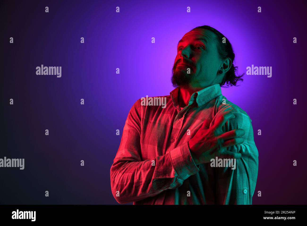 Portrait of emotional young man showing fearful face and pose against ...