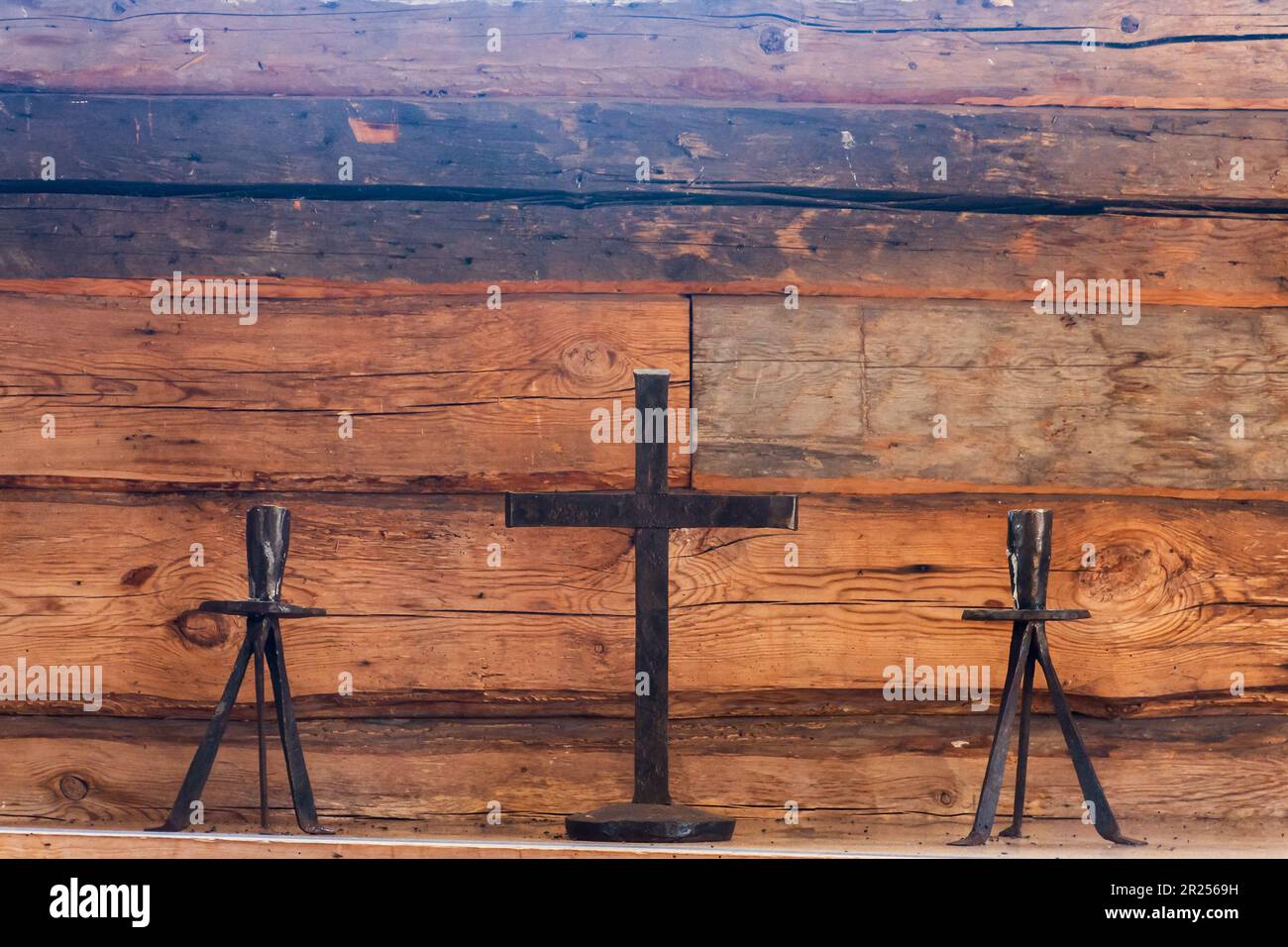Wrought iron cross and candle sticks in an old wooden church of Seili ...