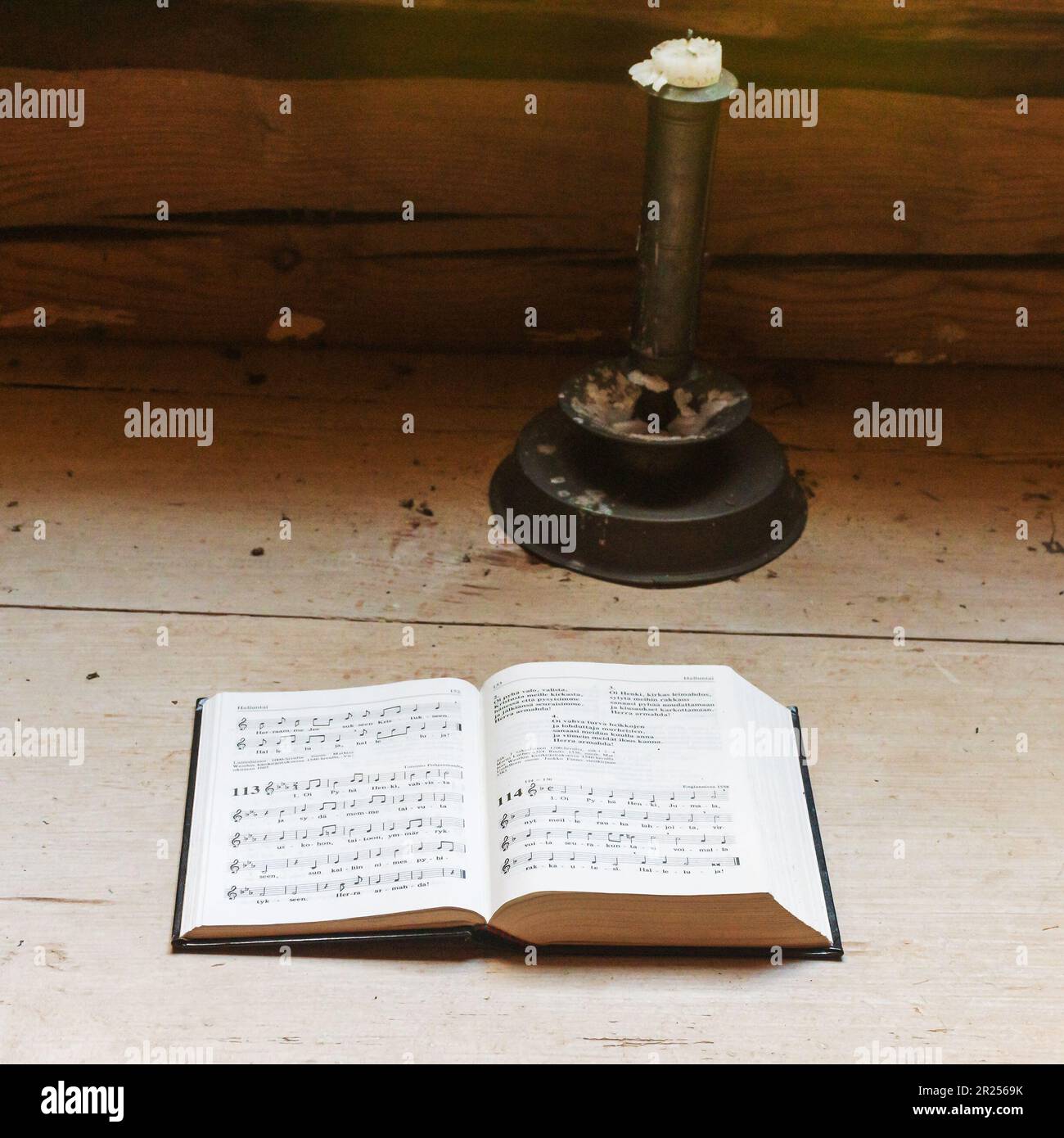 Open hymn book on table in an old wooden church of Seili (Själö) island ...