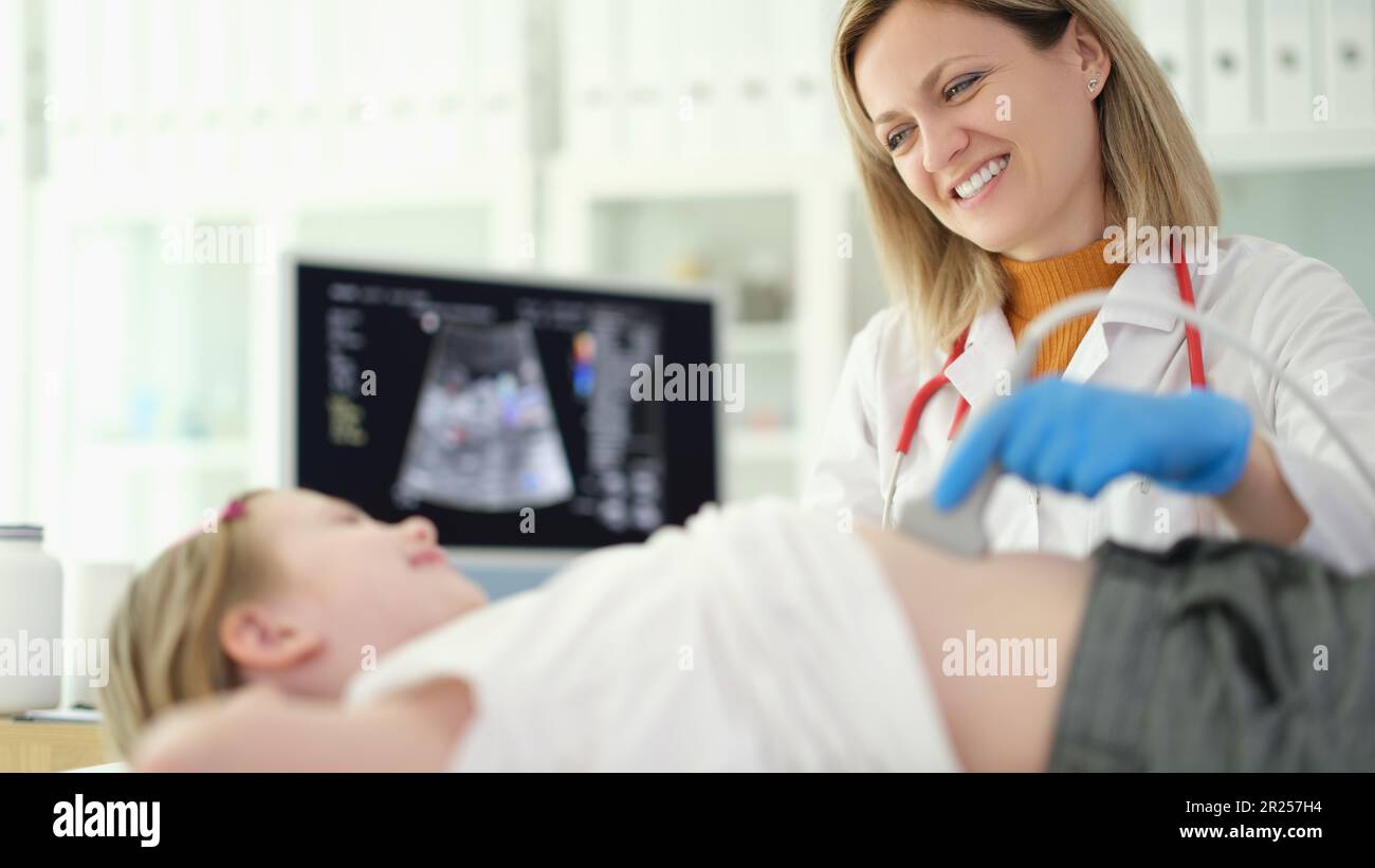Doctor pediatrician making ultrasound examination of abdominal organs ...