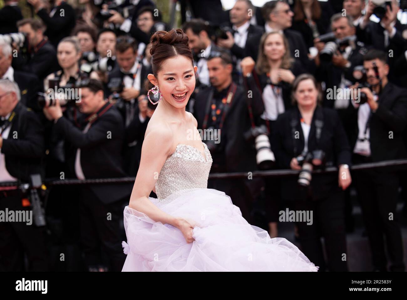 Qian Hui poses for photographers upon arrival at the opening ceremony ...