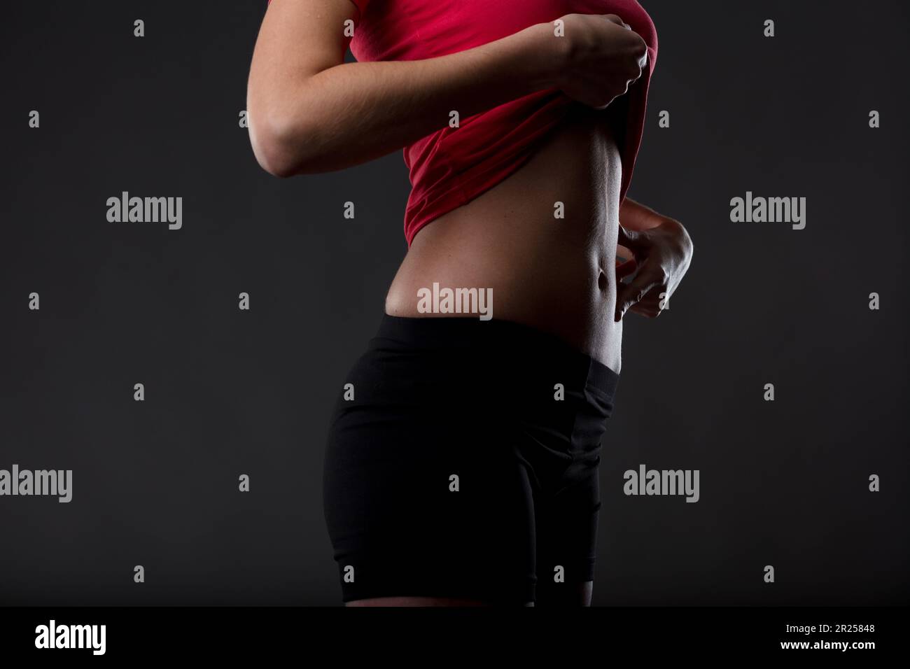 Flat belly proudly displayed by a young woman, proud of her diet ...