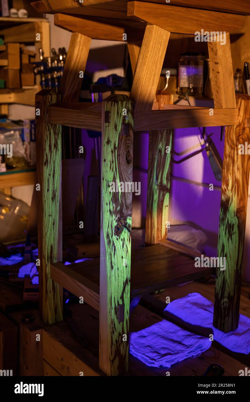 Fluorescing black locust wood used as table legs Stock Photo - Alamy
