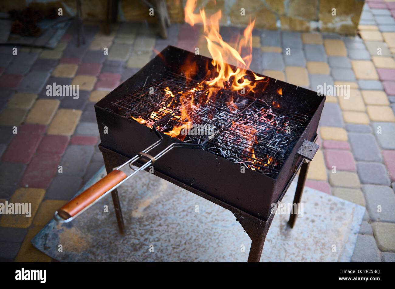 Empty flaming charcoal grill with open fire, ready for product ...
