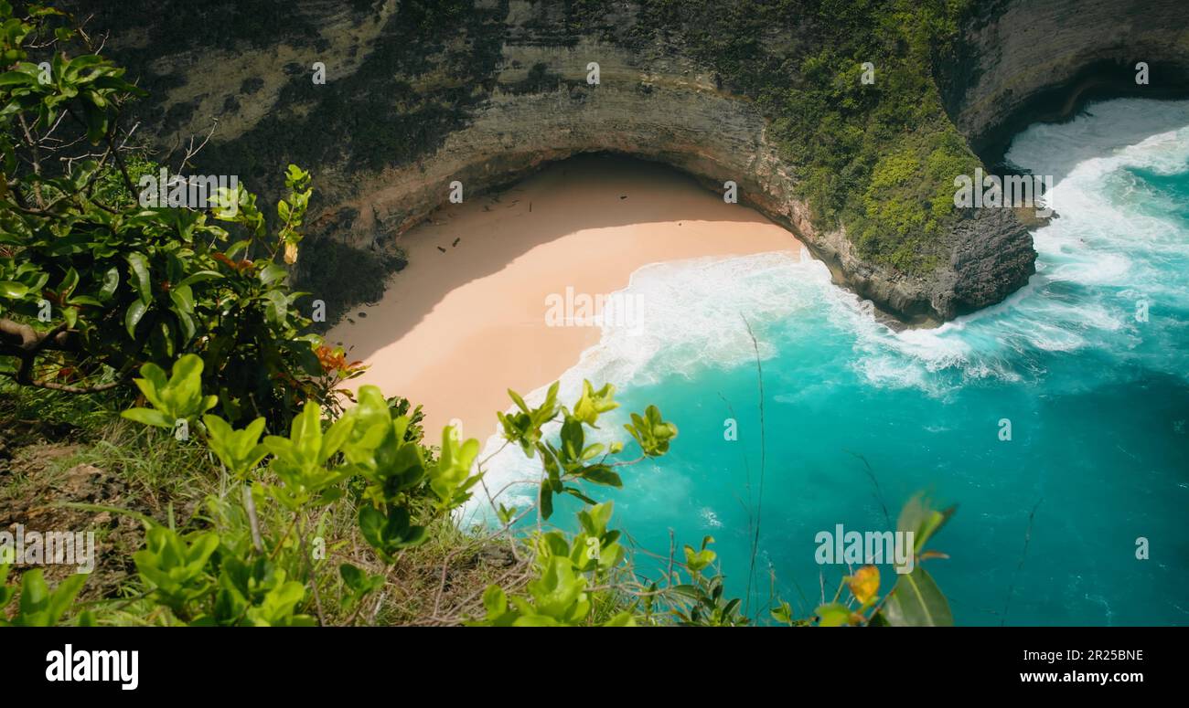 Sandy Kelingking beach with clear ocean water in Bali Nusa Penida Island indonesia. Green ...