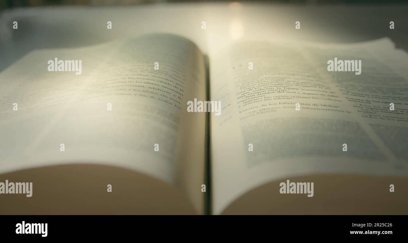 Magical glowing pages of an open book close-up. Reading knowledge ...