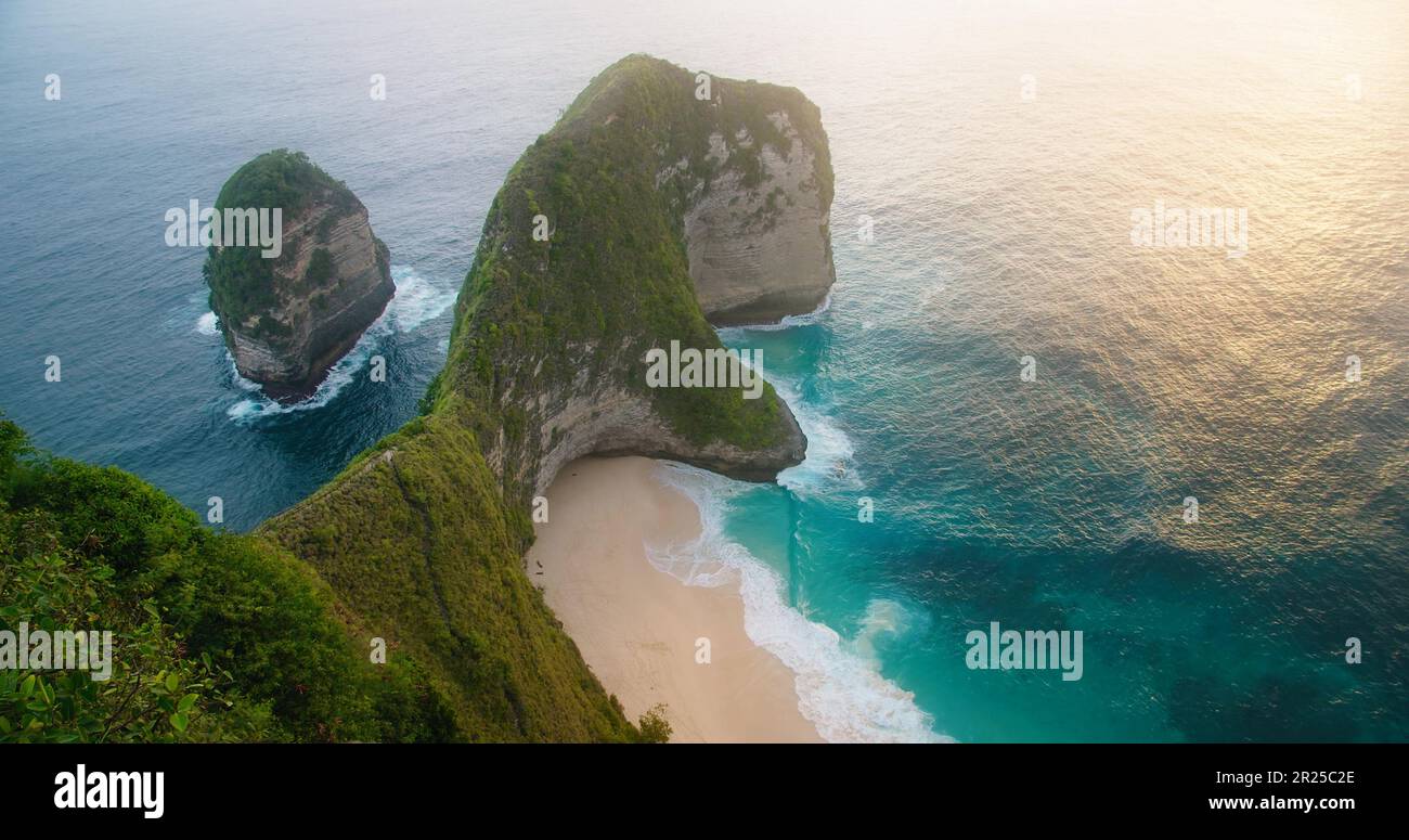 Rainy weather on pristine tropical Kelingking beach with golden sand at ...