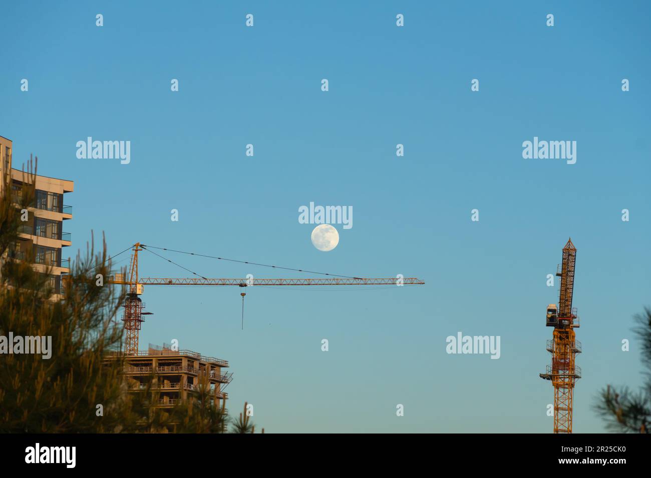 Construction cranes, part of a building under construction against the ...