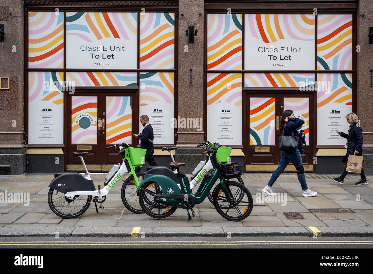 London, UK. 17 May 2023. The public passes electric hire cycles on a ...