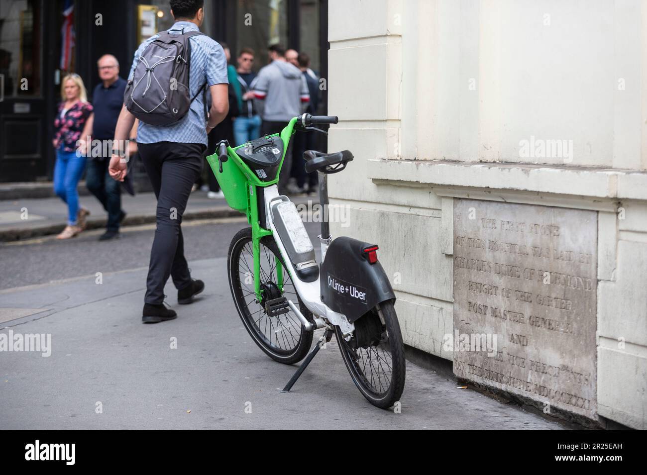 London, UK. 17 May 2023. The public passes an electric hire cycle on a ...