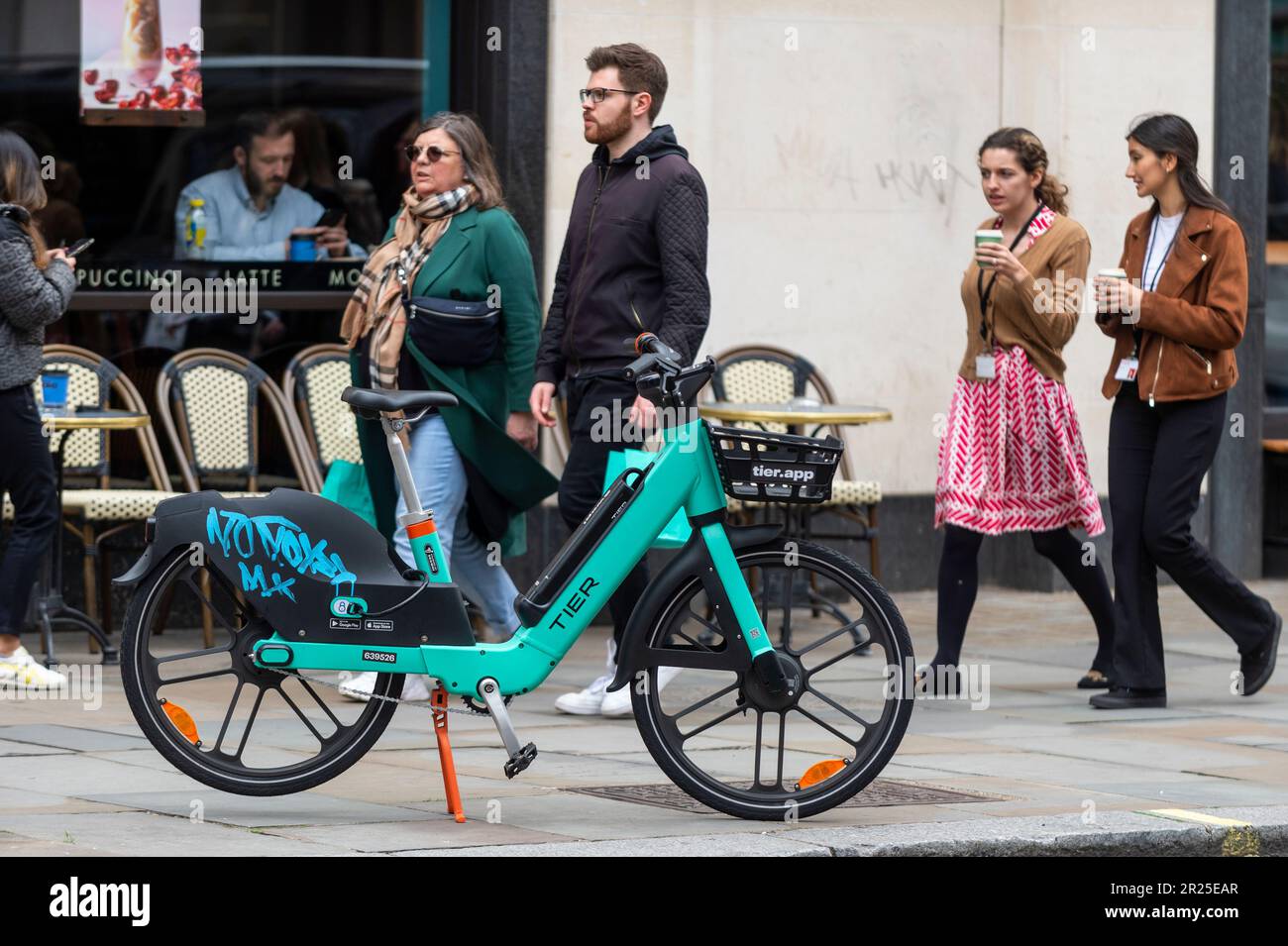 London, UK. 17 May 2023. The public passes an electric hire cycle on a ...