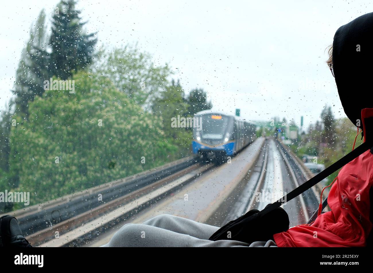 teenage boy sitting in windshield of sky train breaking rules resting ...