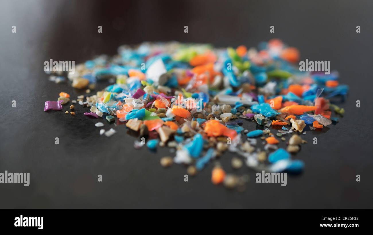 Extreme macro shot on a pile of microplastic particles and sand ...