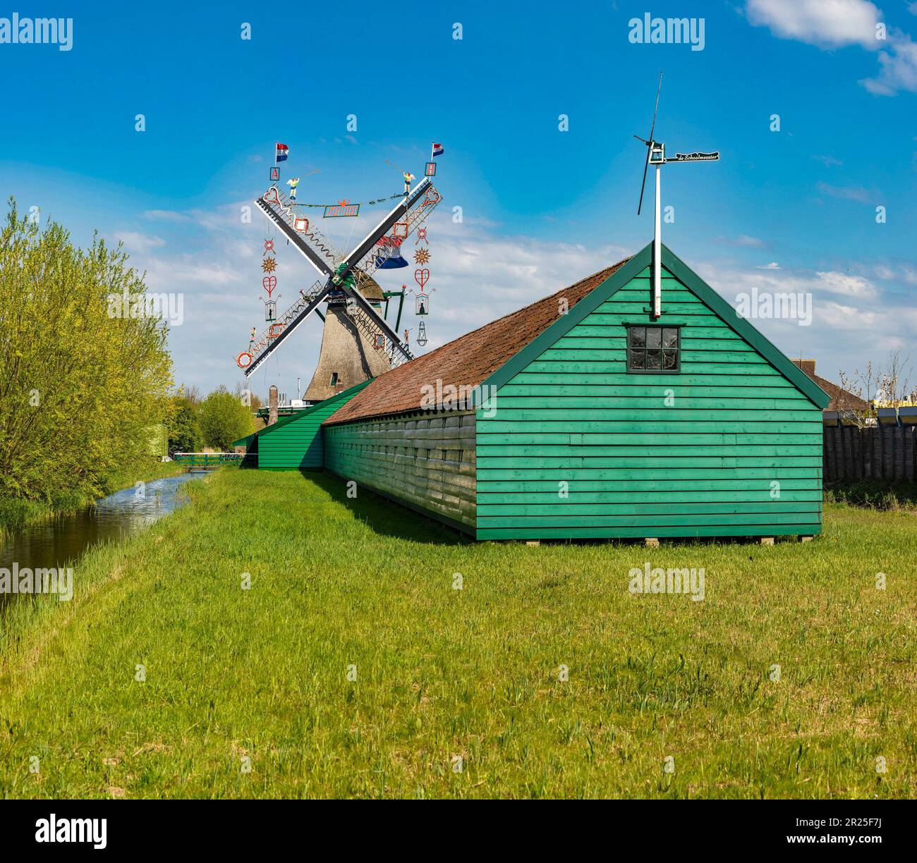 Paper producing windmill called De Schoolmeester with decorated wings ...