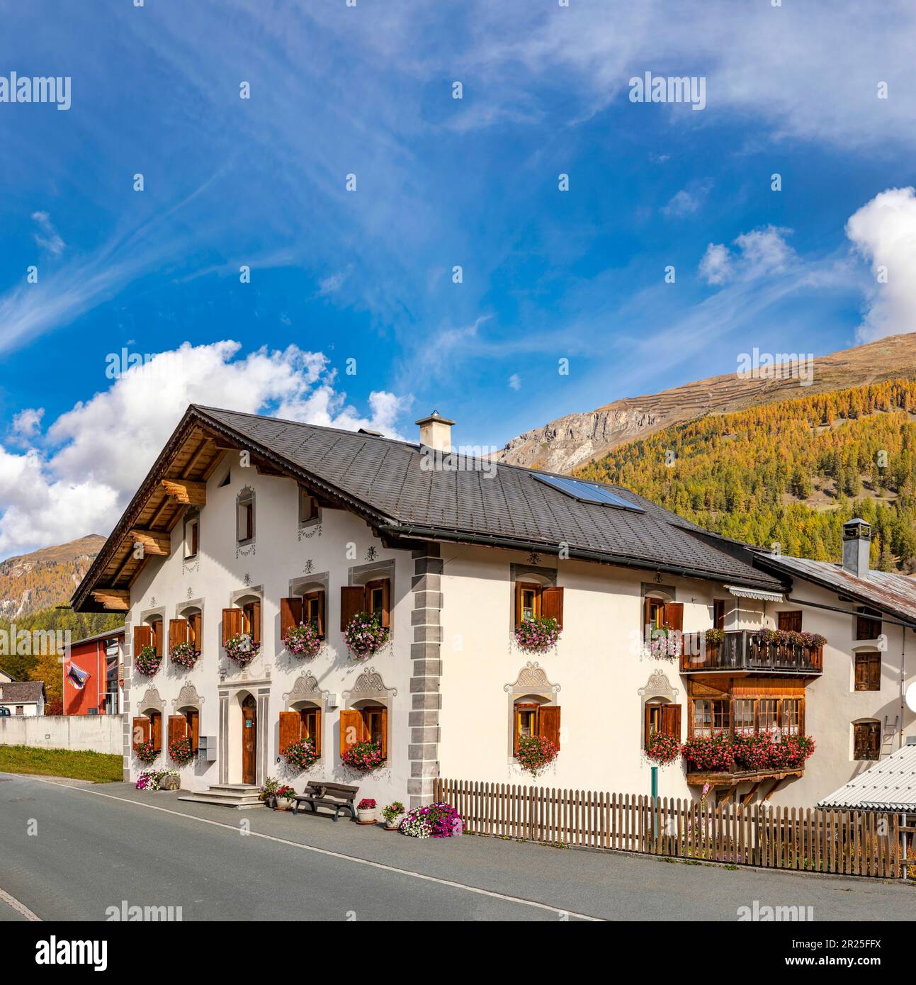 The Hauptstrasse in a Engadine village, House with flower boxes ...
