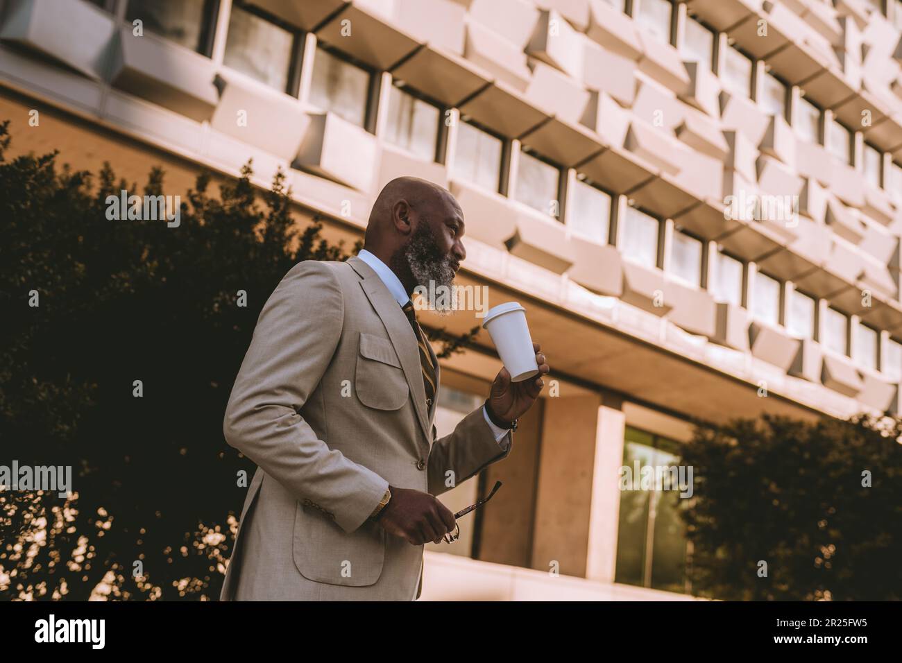 Lisbon; A dandy bald white-bearded black man, outside his colorful ...