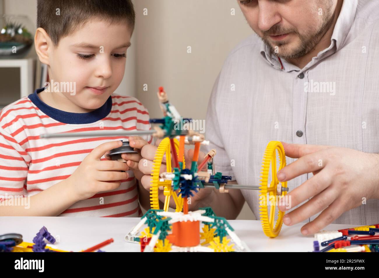 Dad and son build figures from the constructor. Spending time together ...