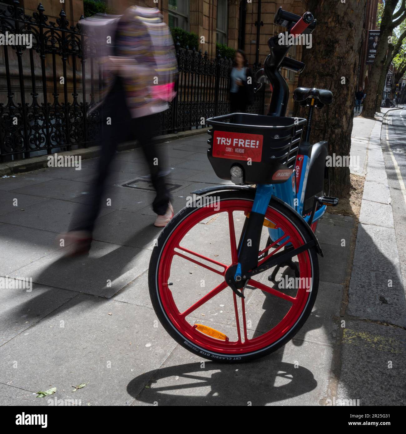 London, UK. 17 May 2023. The public passes an electric hire cycle on a ...