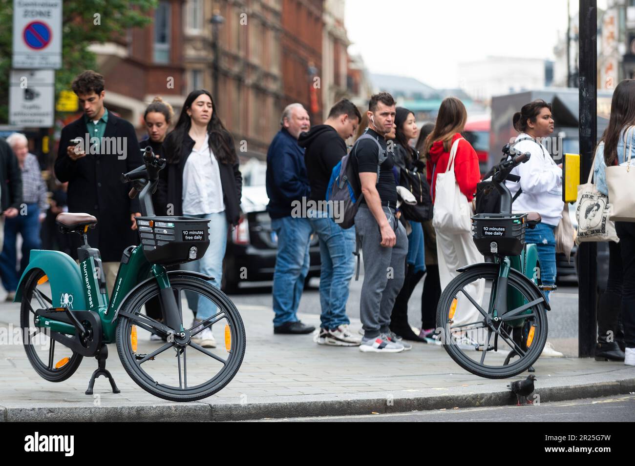 London, UK. 17 May 2023. The public passes electric hire cycles on a ...