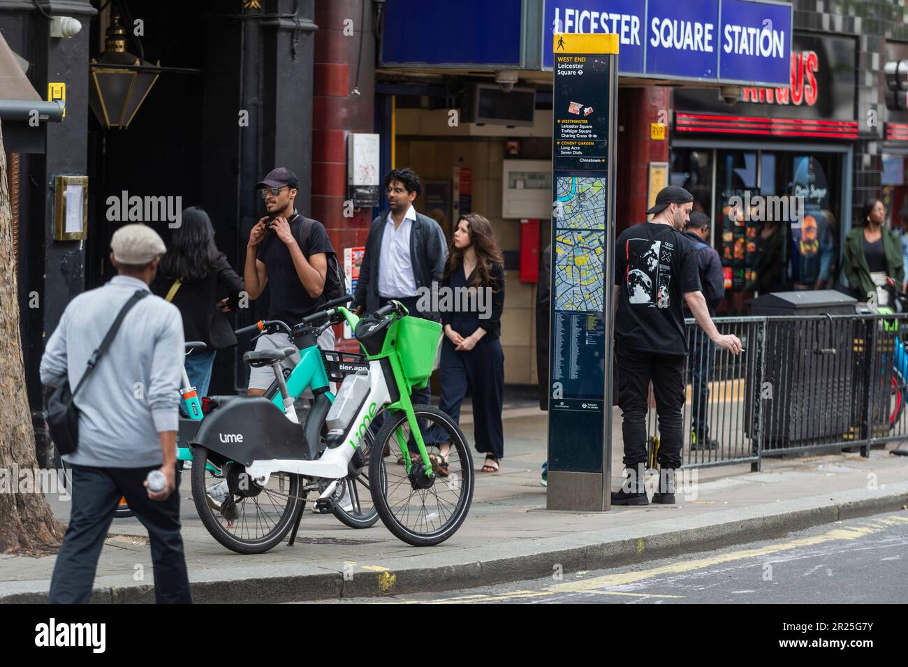 London, UK. 17 May 2023. The public passes electric hire cycles on a ...