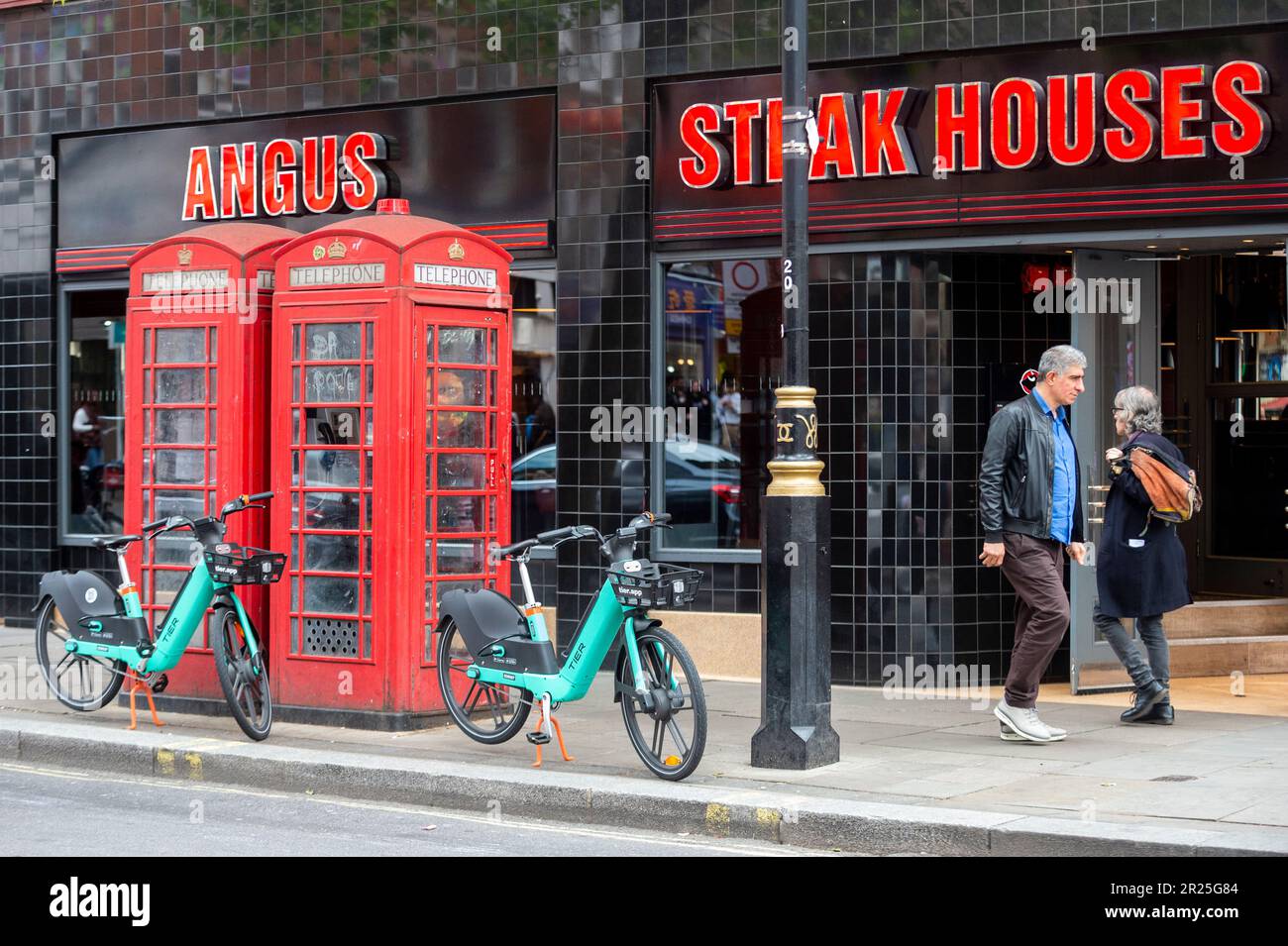 London, UK. 17 May 2023. The public passes electric hire cycles on a ...