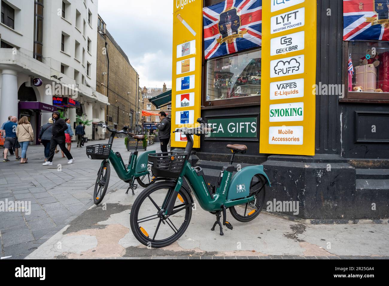 London, UK. 17 May 2023. The public passes electric hire cycles on a ...