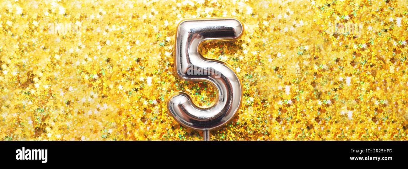 Five years birthday party. Festive silver big number five with golden ...