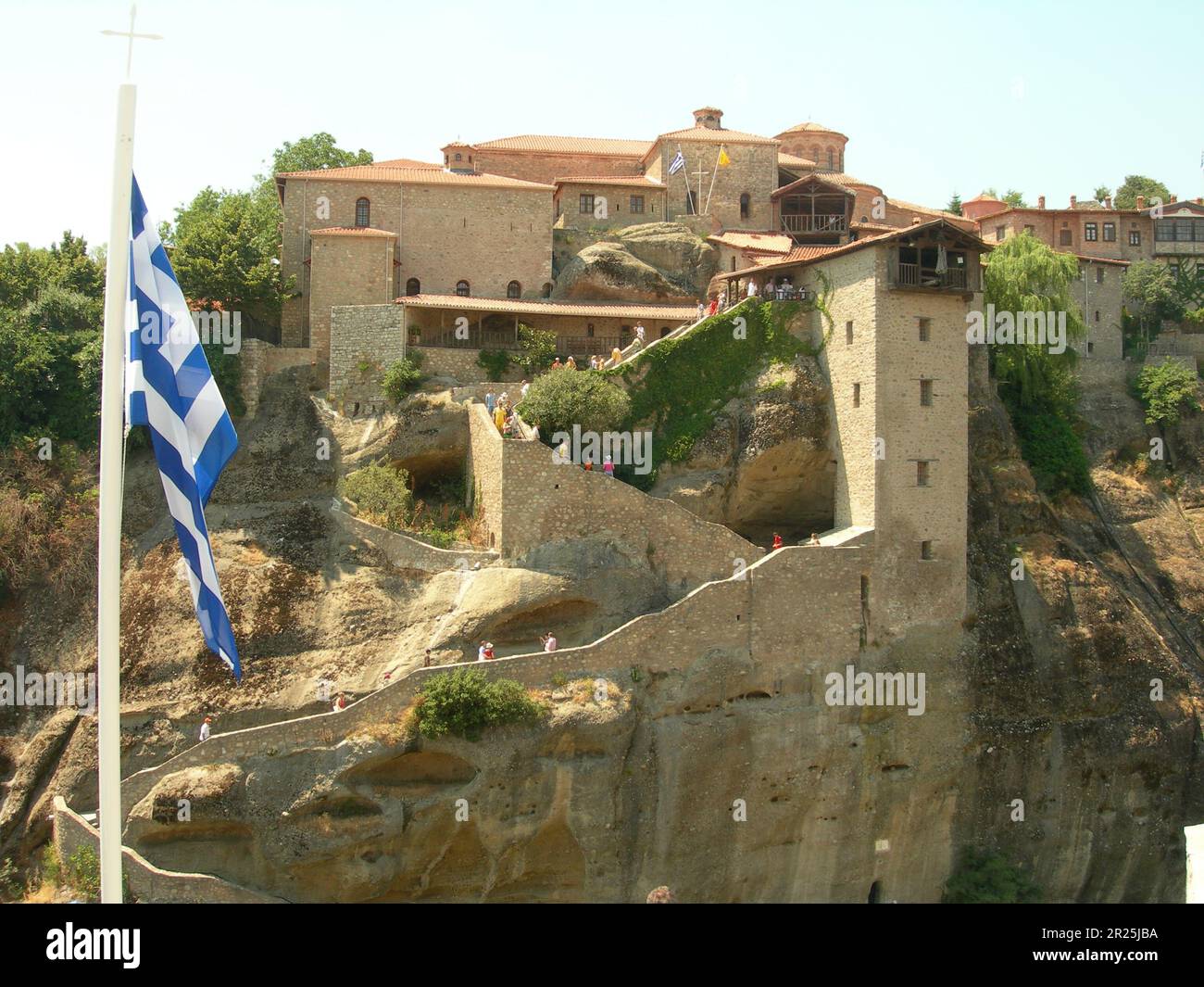 A greek town besides the rock cliffs of Meteora in central Greece on a ...