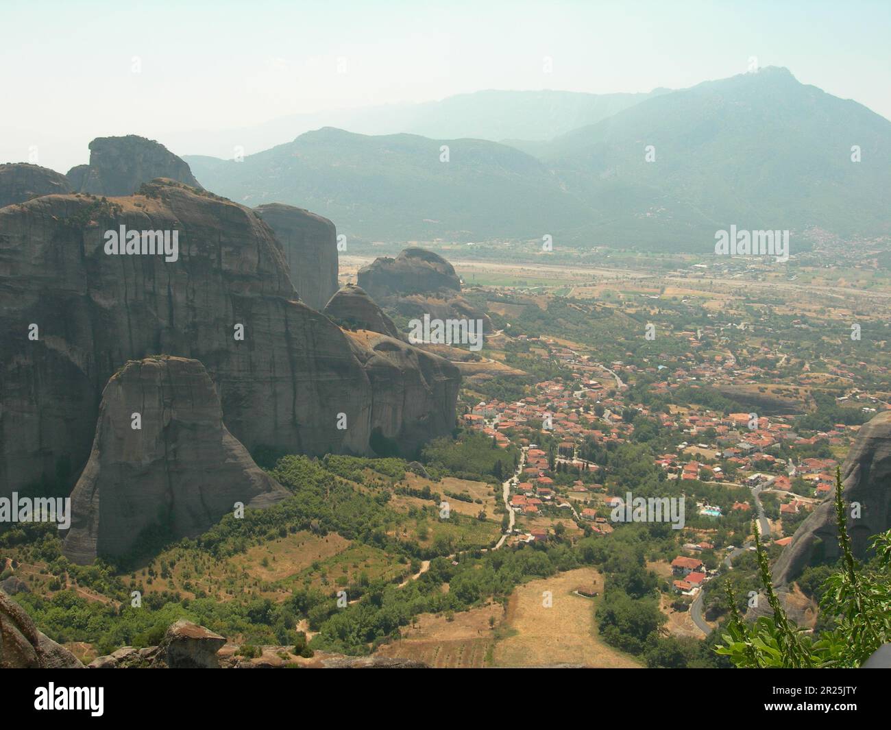 A greek town besides the rock cliffs of Meteora in central Greece on a ...