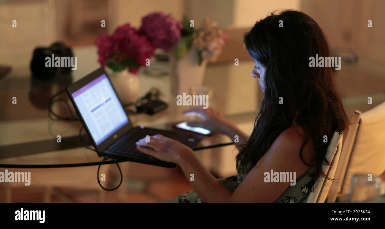 Woman in front of computer browsing internet. Female working working ...