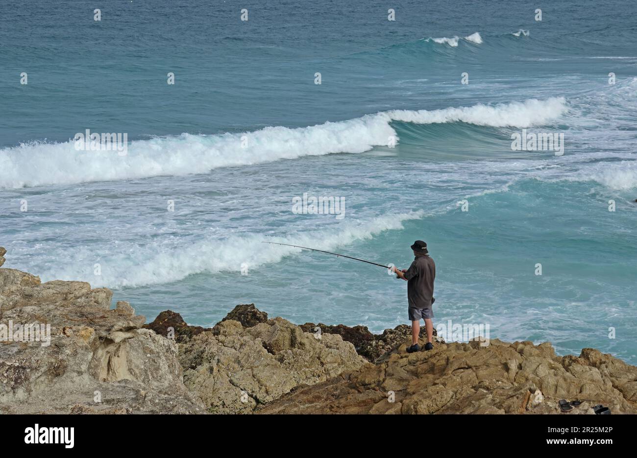Angler fishing from rocks hi-res stock photography and images - Alamy