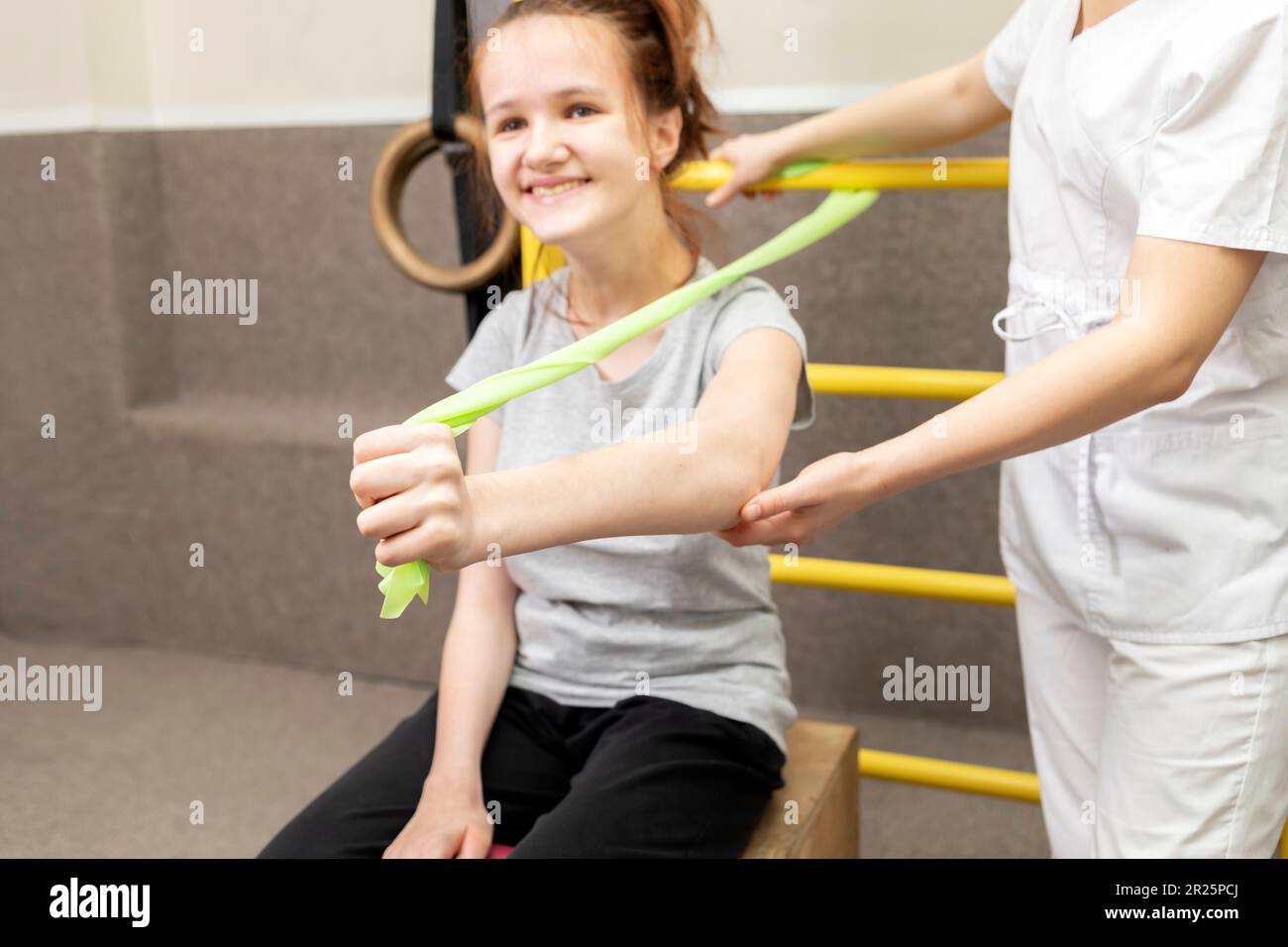 Happy Child With Disability Does Physical Exercises With Support Of ...