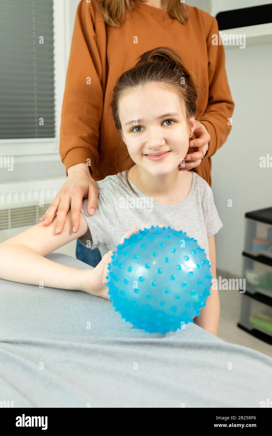 Portrait Of Pretty Smiling Teenager With Disability With Mom Hugging ...