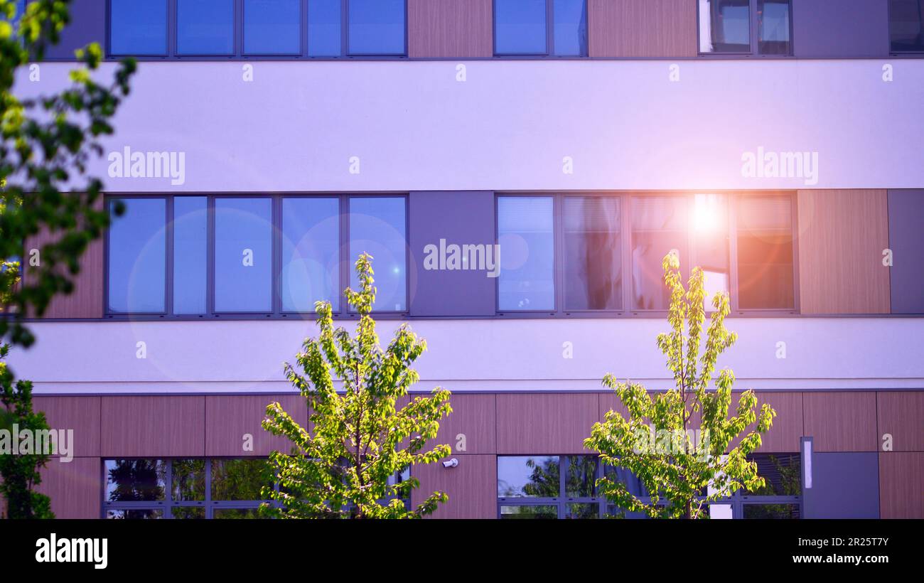 Reflection of modern commercial building on glass with sunlight. Eco ...
