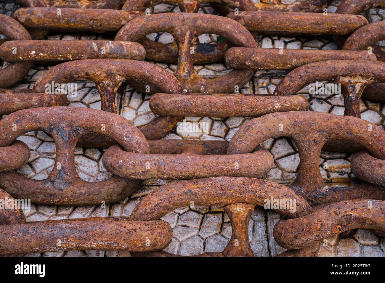 Old rusty ship's chain on the pier, top view. Idea for the background ...