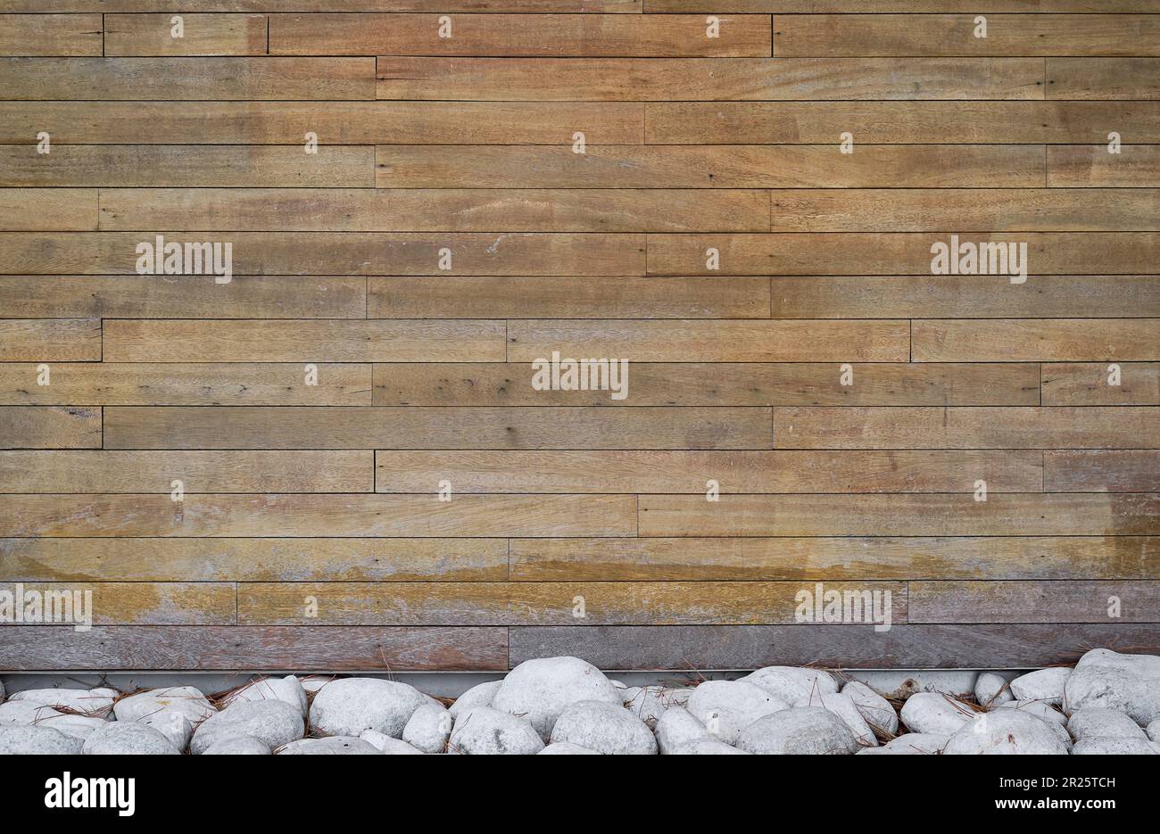 Background of boards and decor of stones on the bottom of the wall ...