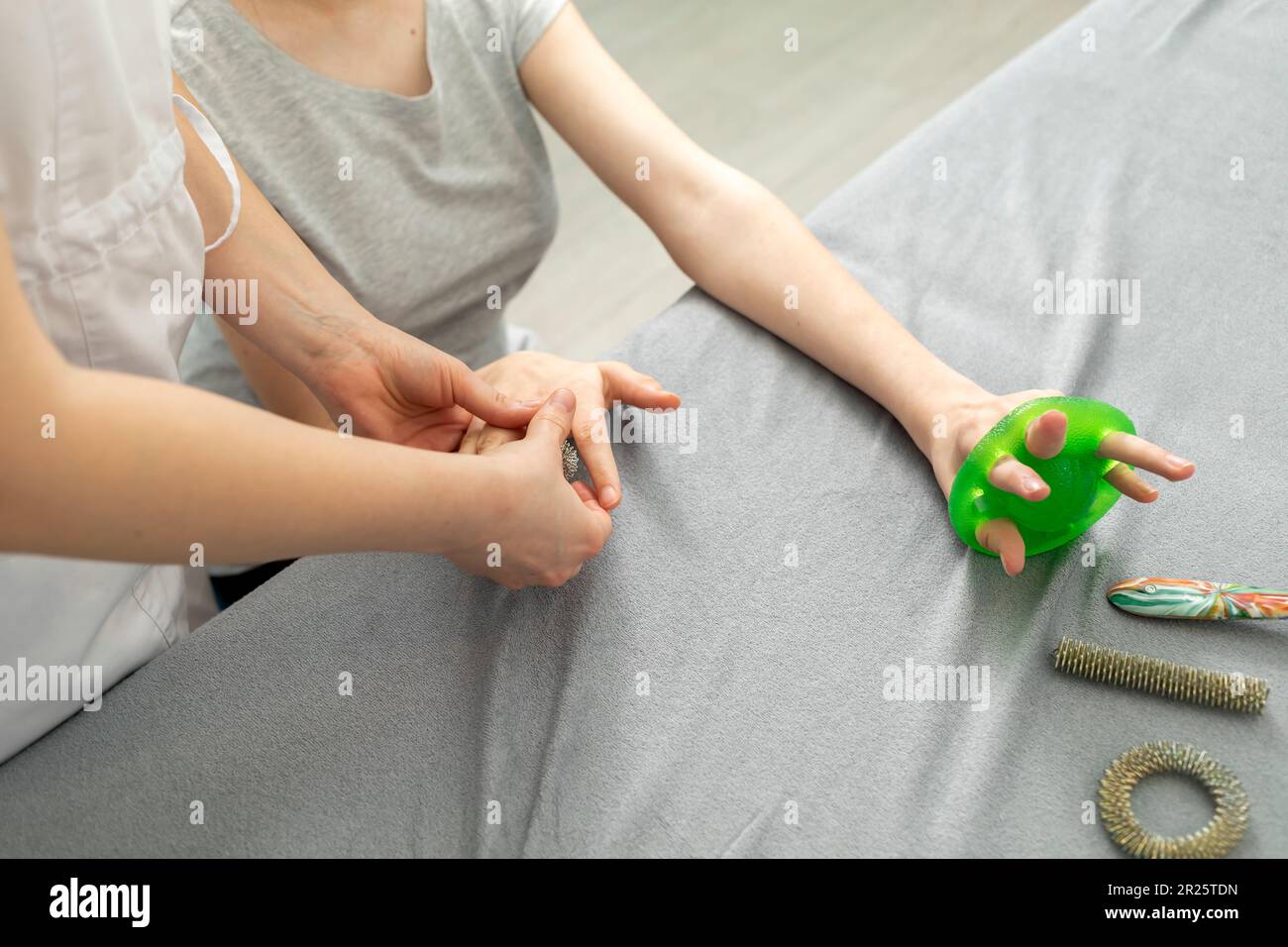 Unrecognizable Doctor Neurologist Stretches Fingers Of Female Young ...