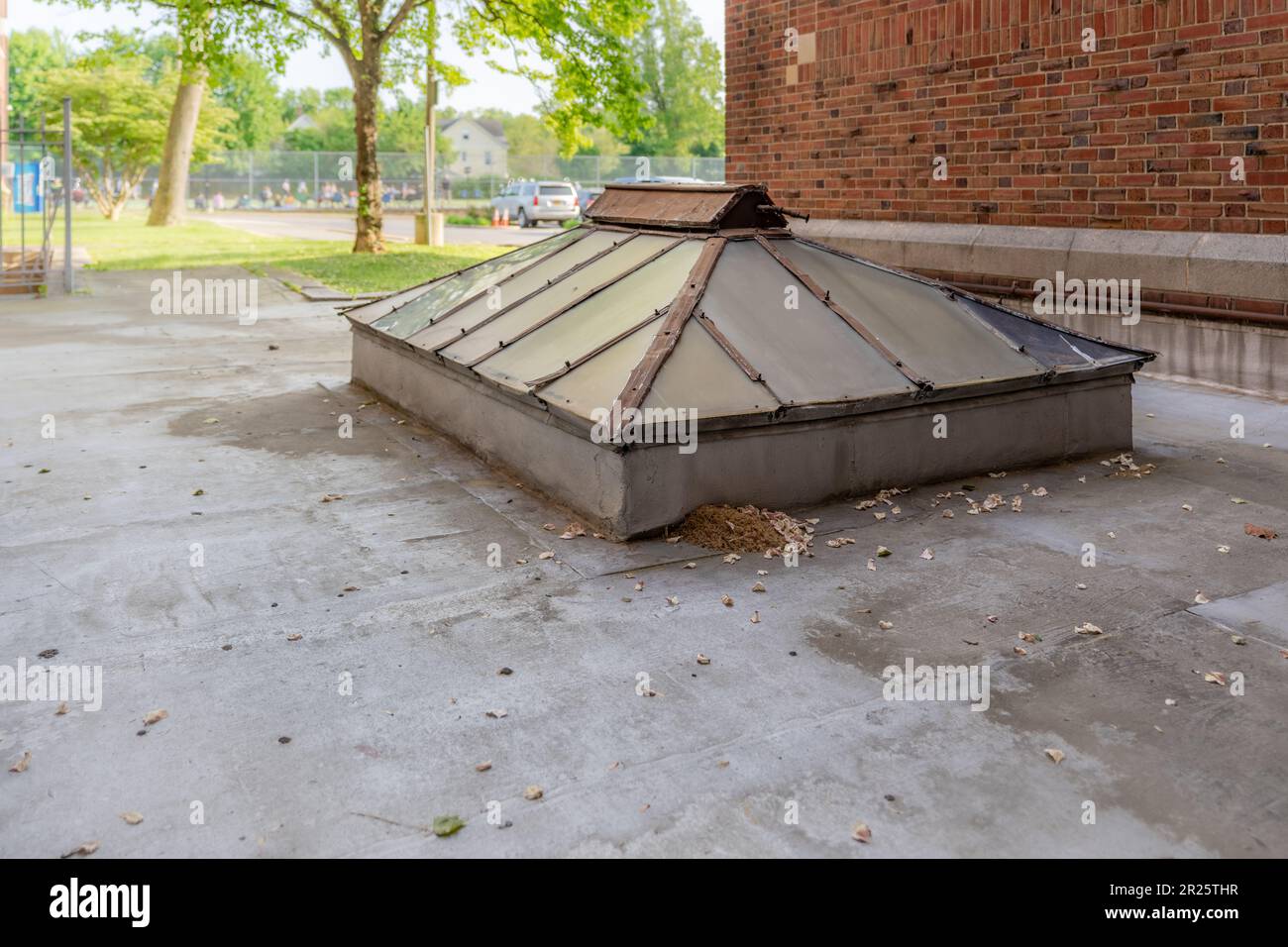 Old, vintage metal framed double pitched skylight on a flat commercial ...