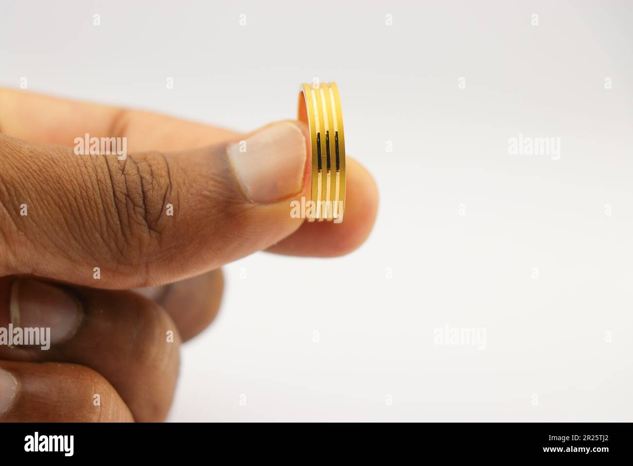 The gold ring held in the hand. Beautiful wedding ring made from gold ...