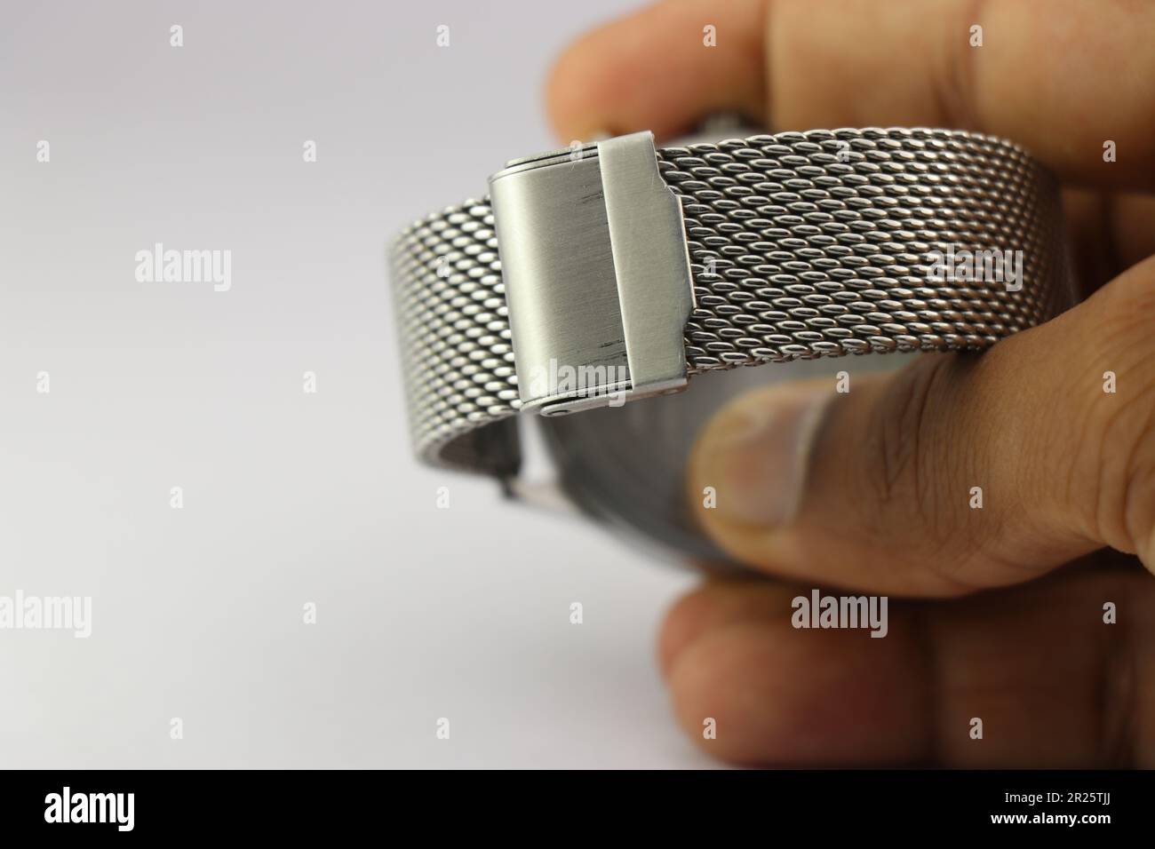 Stainless steel mesh strap of a watch held in the hand Stock Photo - Alamy