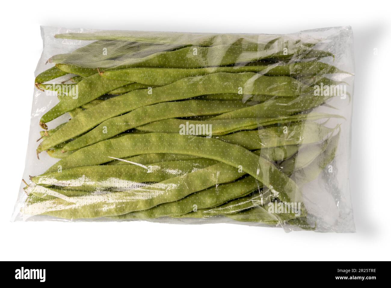 Runner beans packaged in clear plastic bag for sale isolated on white ...